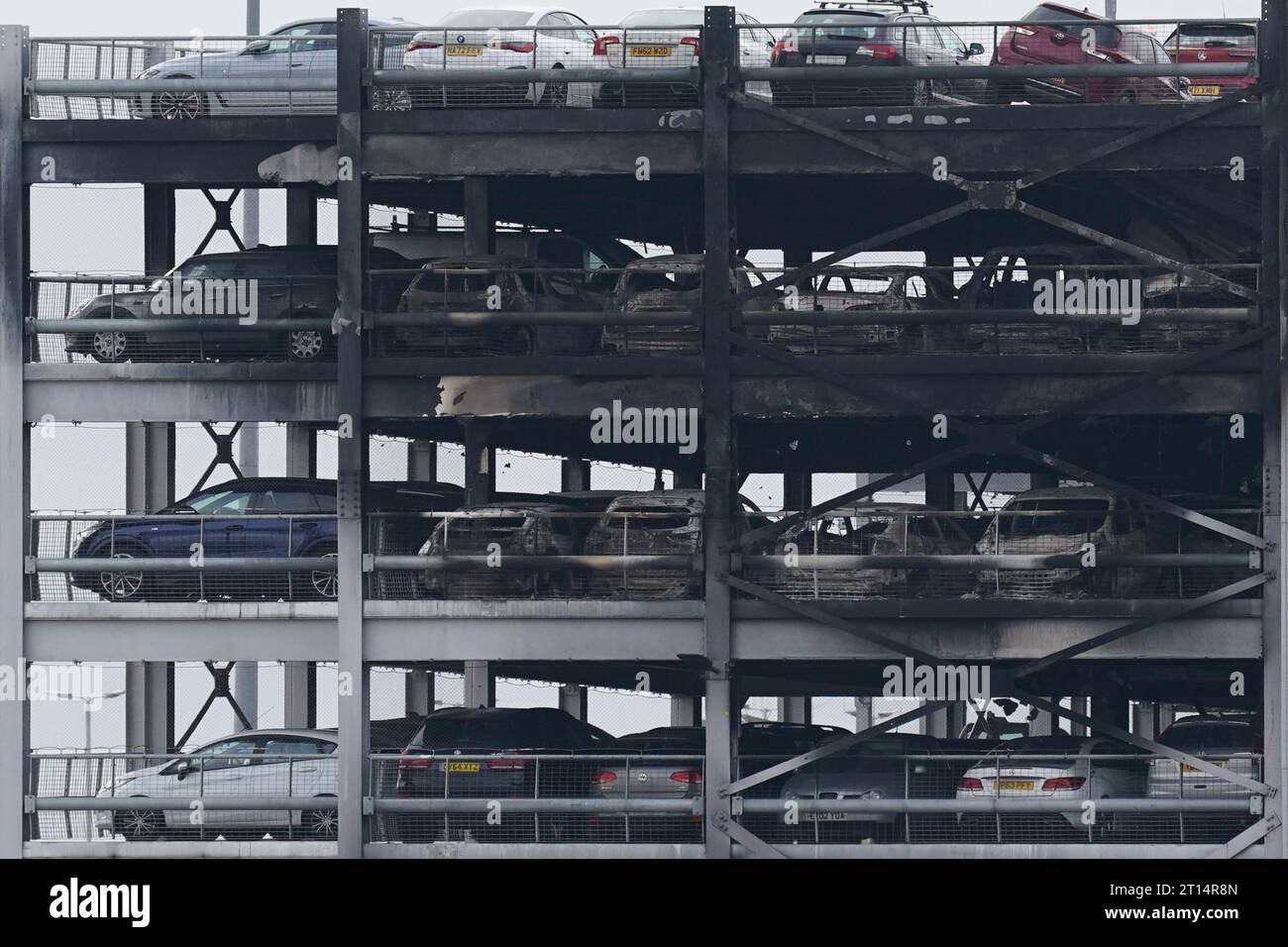 The burnt out shells of cars, buried amongst debris of a multi-storey ...