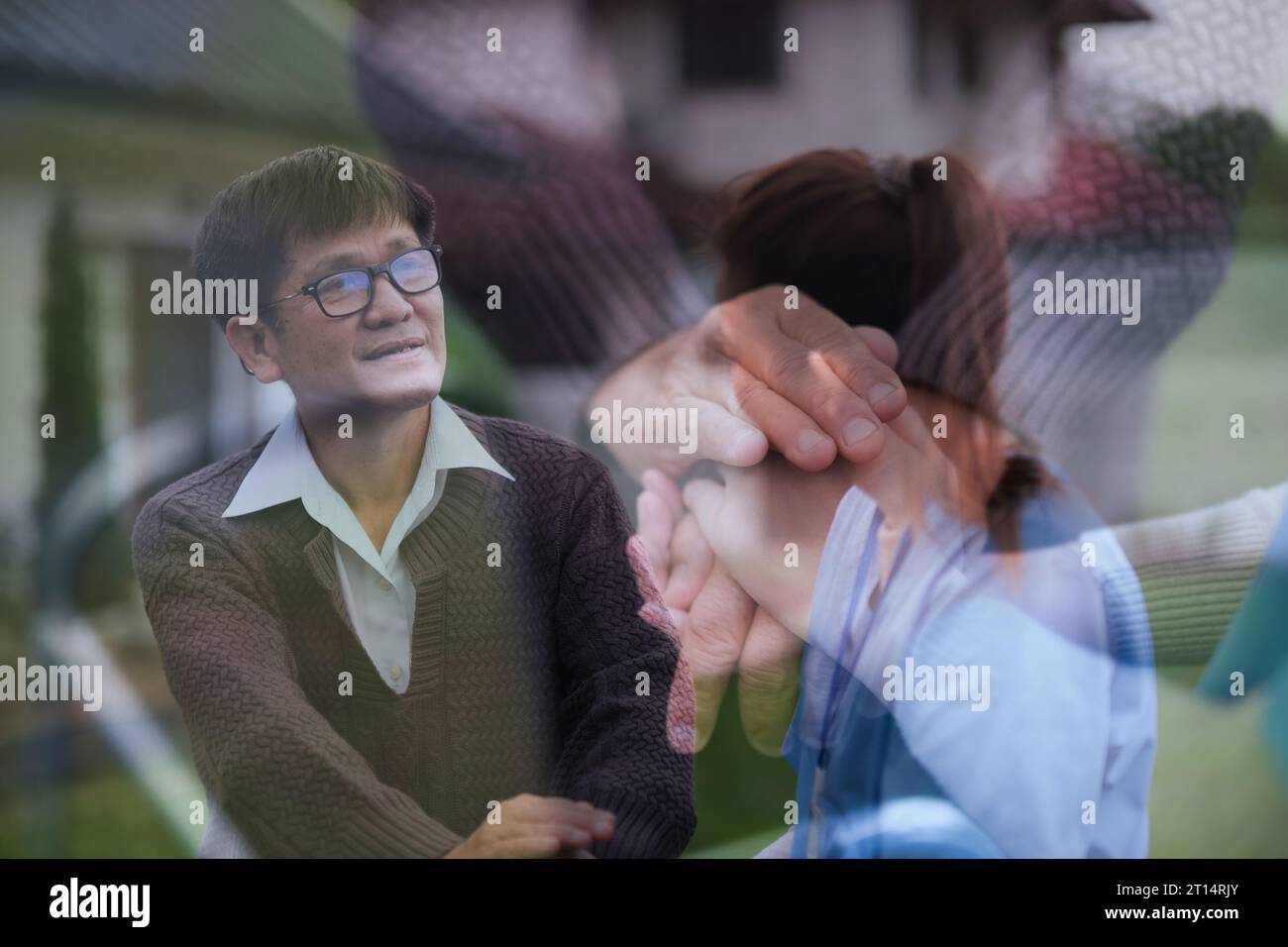Double exposure physical therapist caregiver talking to senior man ...