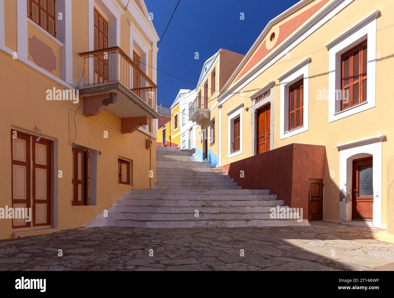 Colorful facades of traditional Greek multi-colored houses on a narrow ...