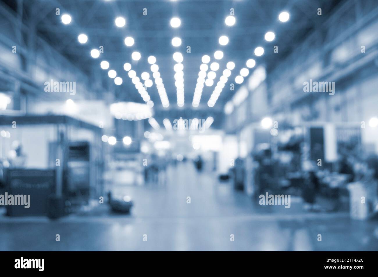 Large high building premises with people walking inside. Blurred ...