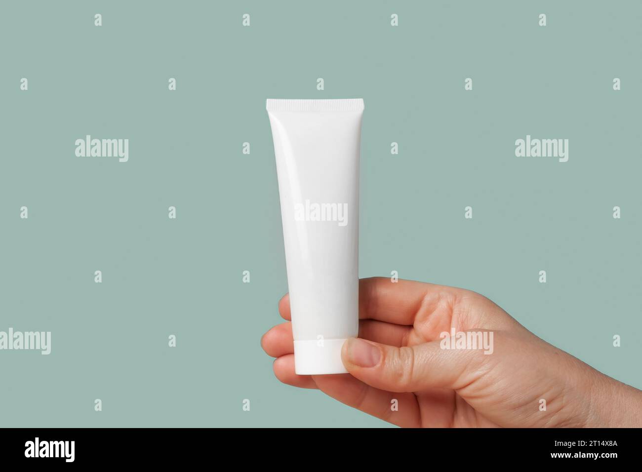 White Cream Package Template in Female Hand. Green Background. Natural ...