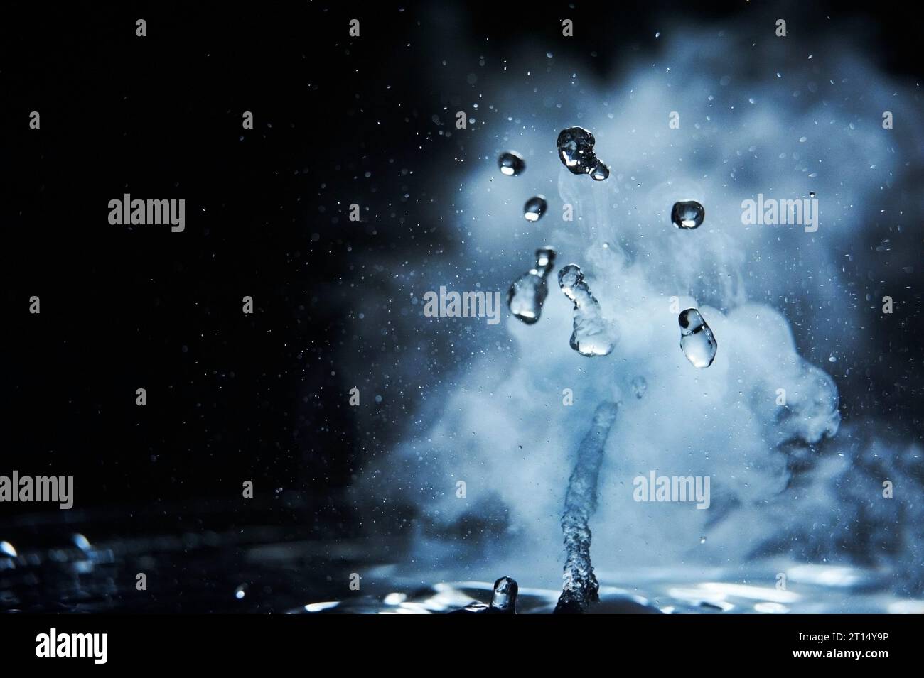 Boiling water splash with steam on black background closeup Stock Photo ...