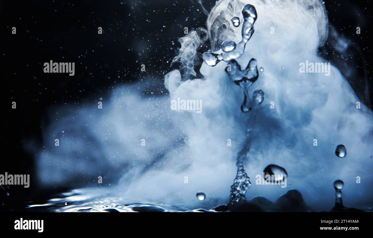 Boiling water splash with steam on black background closeup Stock Photo ...