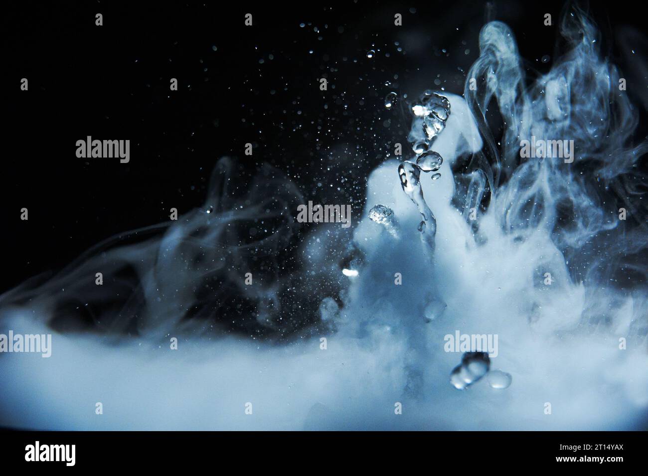 Boiling water splash with steam on black background closeup Stock Photo ...