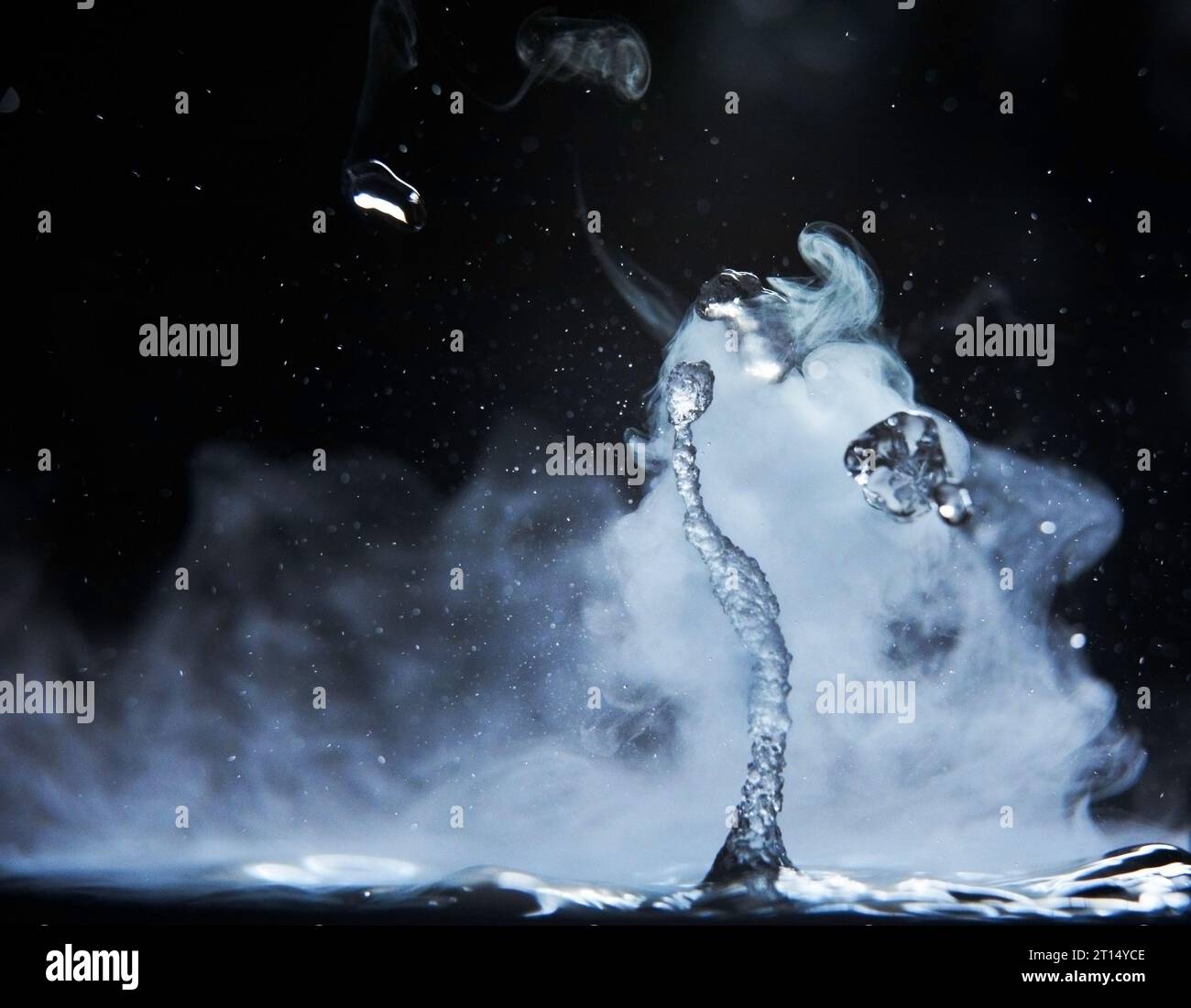 Boiling water splash with steam on black background closeup Stock Photo ...