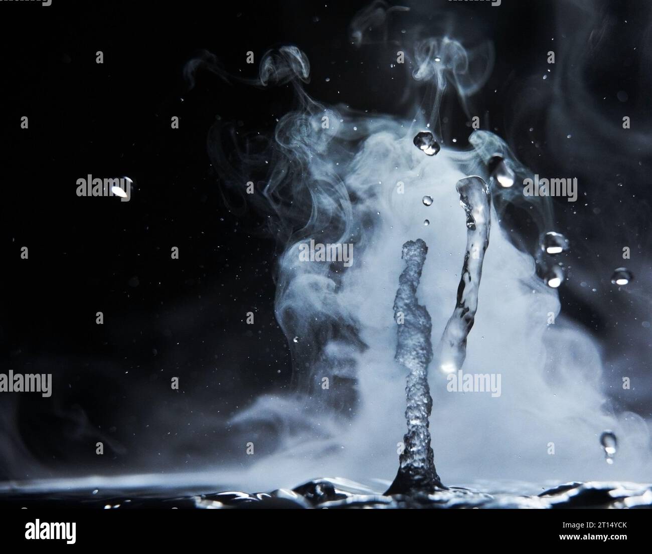 Boiling water splash with steam on black background closeup Stock Photo ...