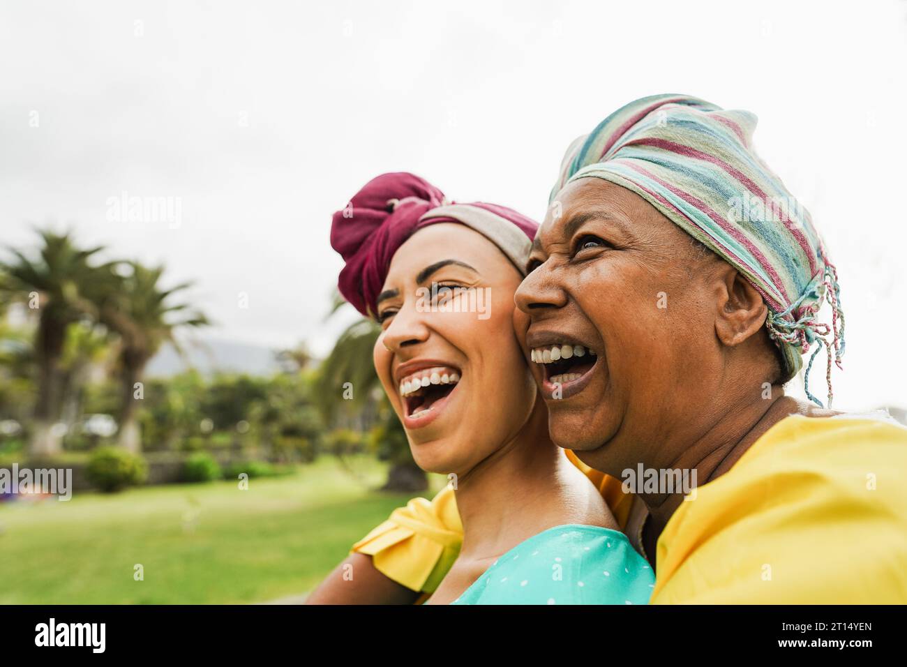 Happy african mother and daughter wearing traditional clothes while ...