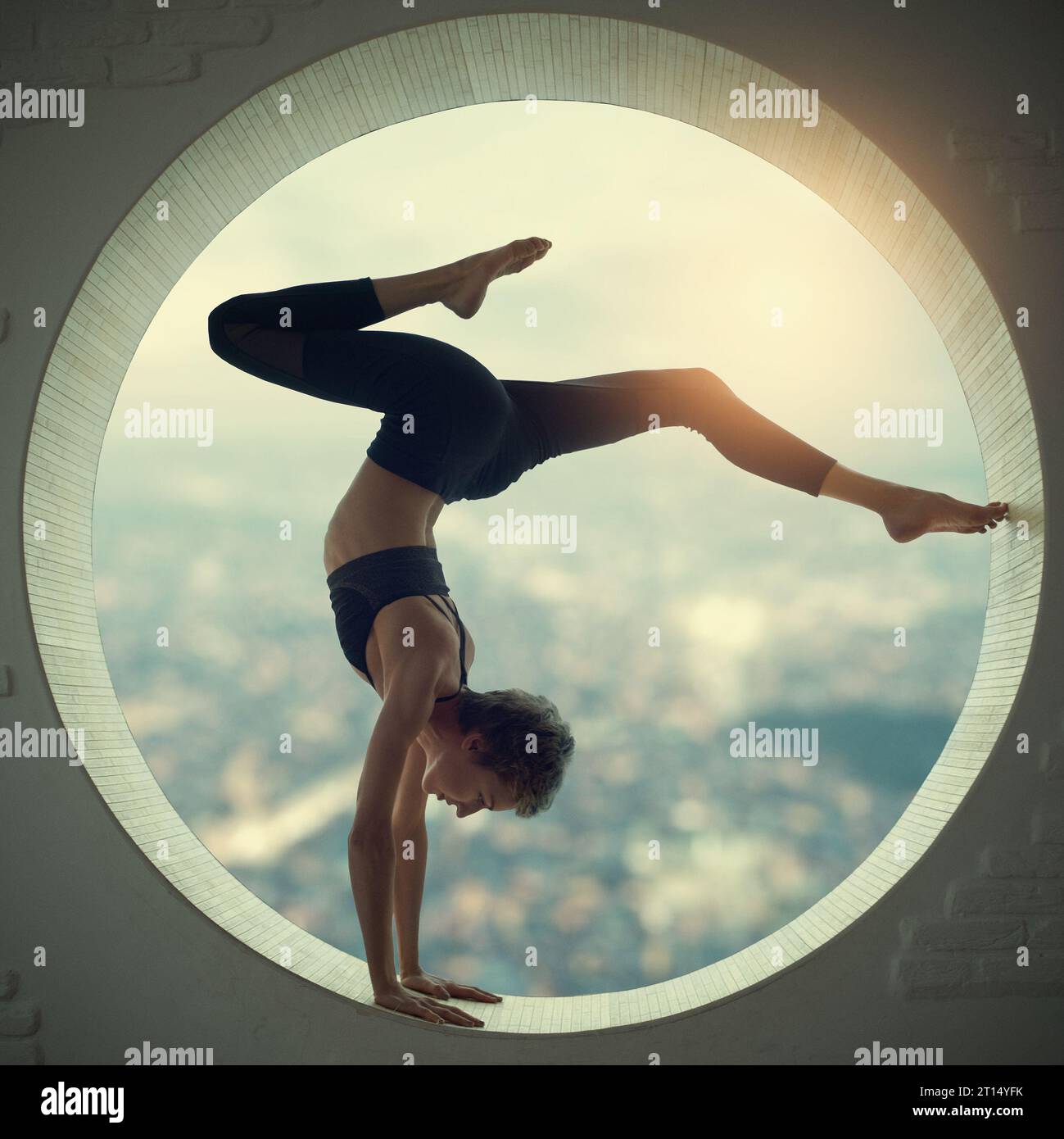 Beautiful sporty fit yogi woman practices yoga handstand asana Bhuja ...