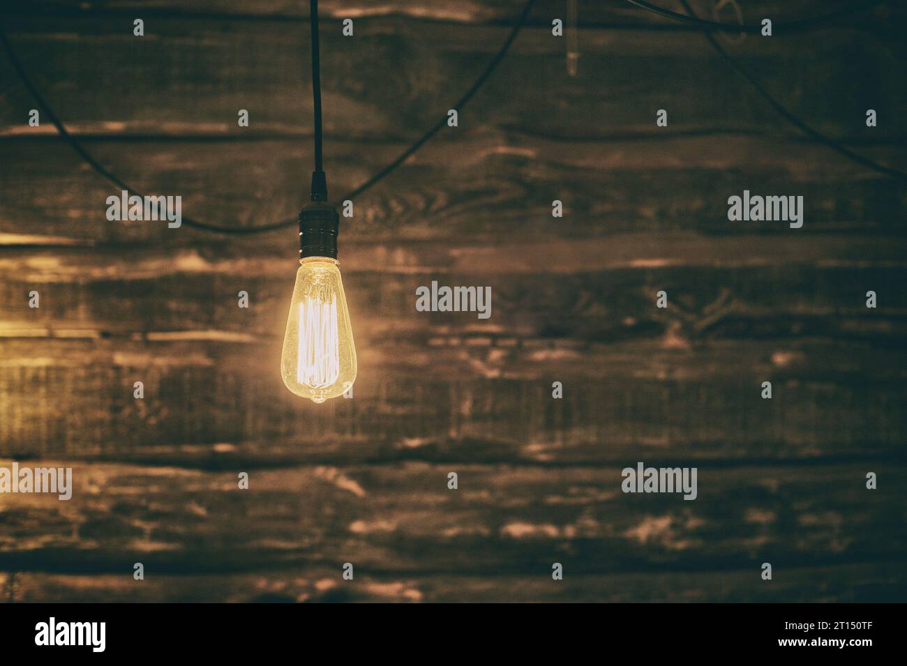 Light Edison bulb on dark wooden background. vintage effect Stock Photo ...