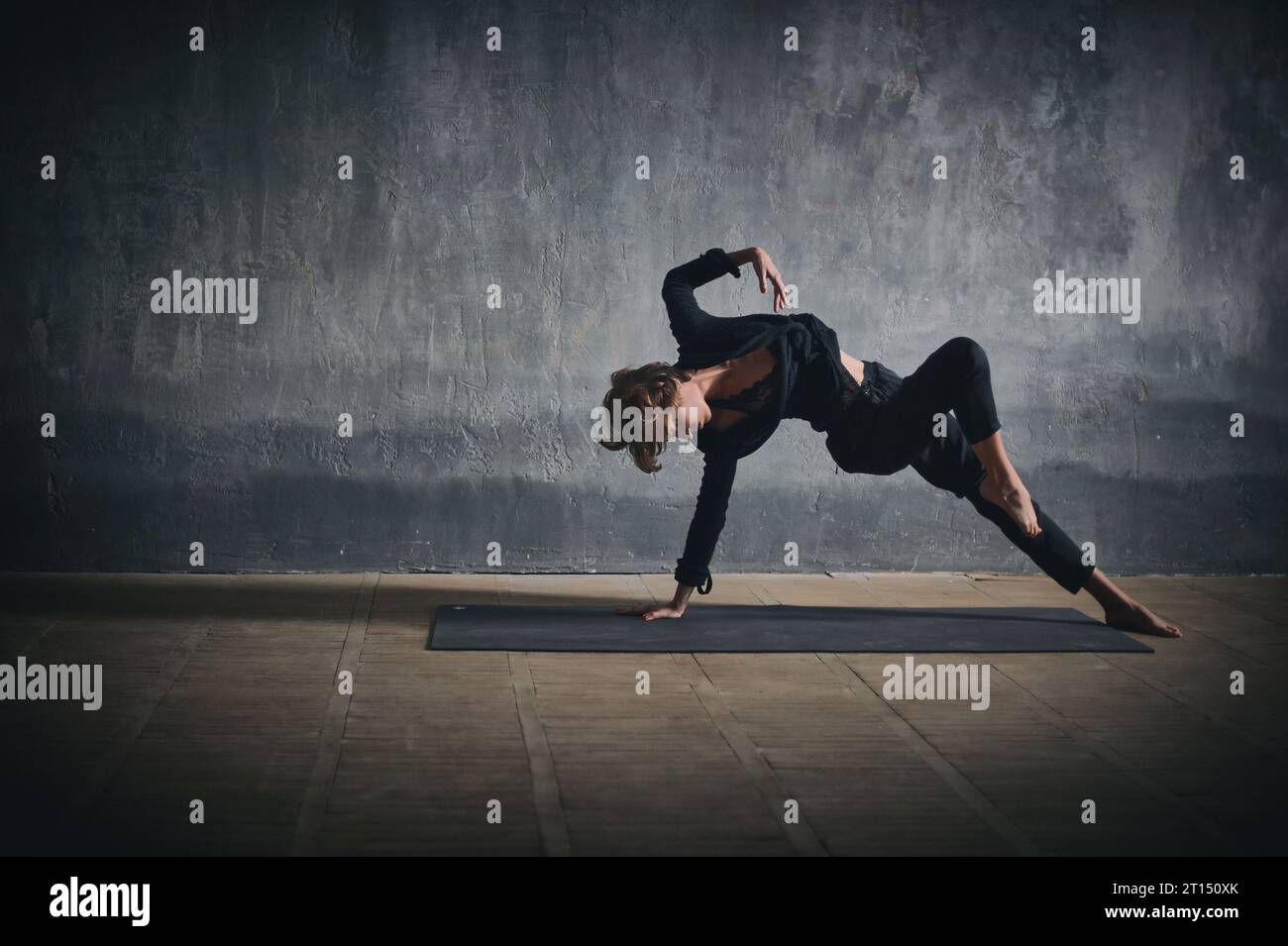 Beautiful sporty fit yogini woman practices yoga asana Wild Thing Pose ...