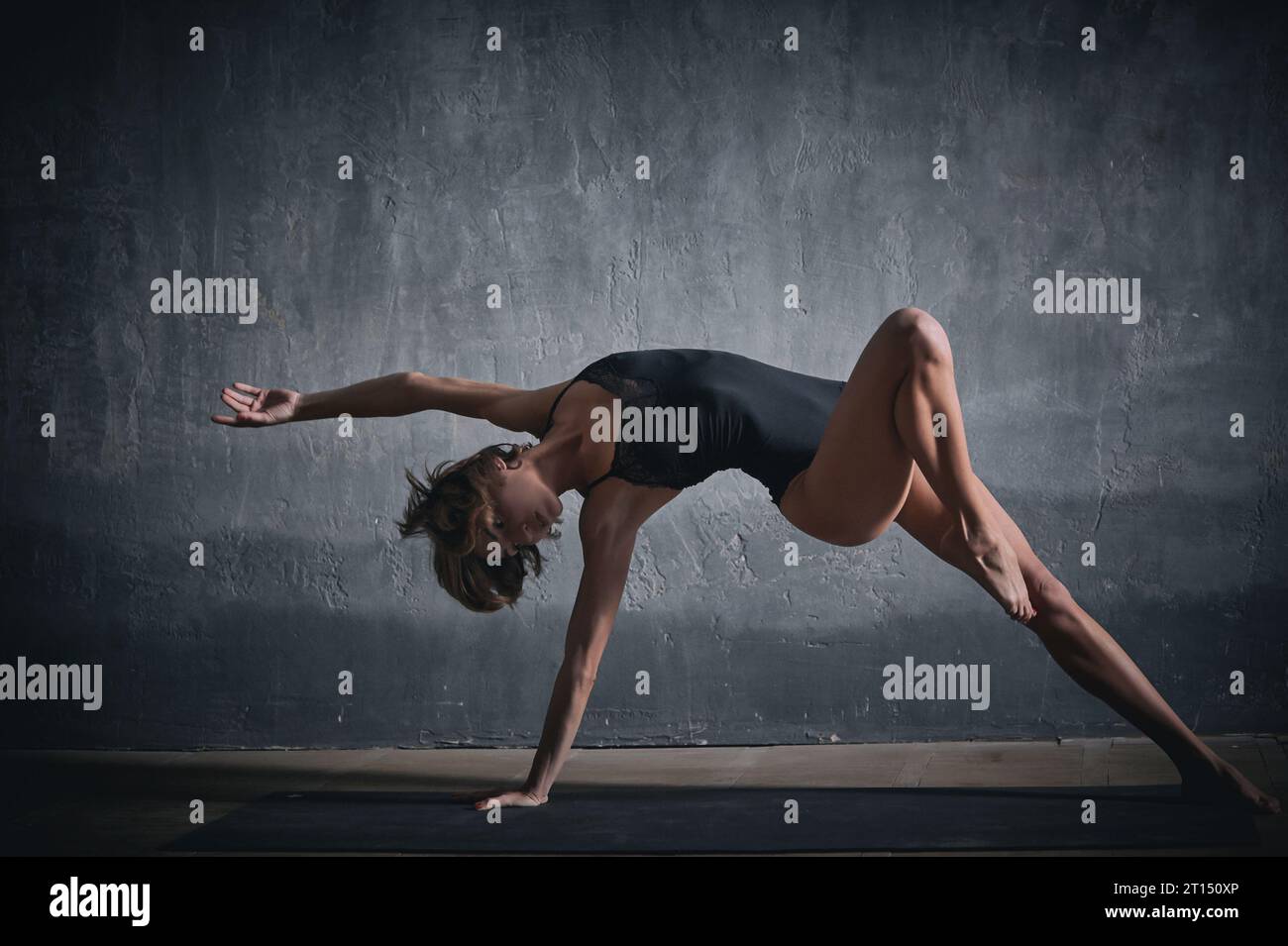 Beautiful sporty fit yogini woman practices yoga asana Wild Thing Pose ...