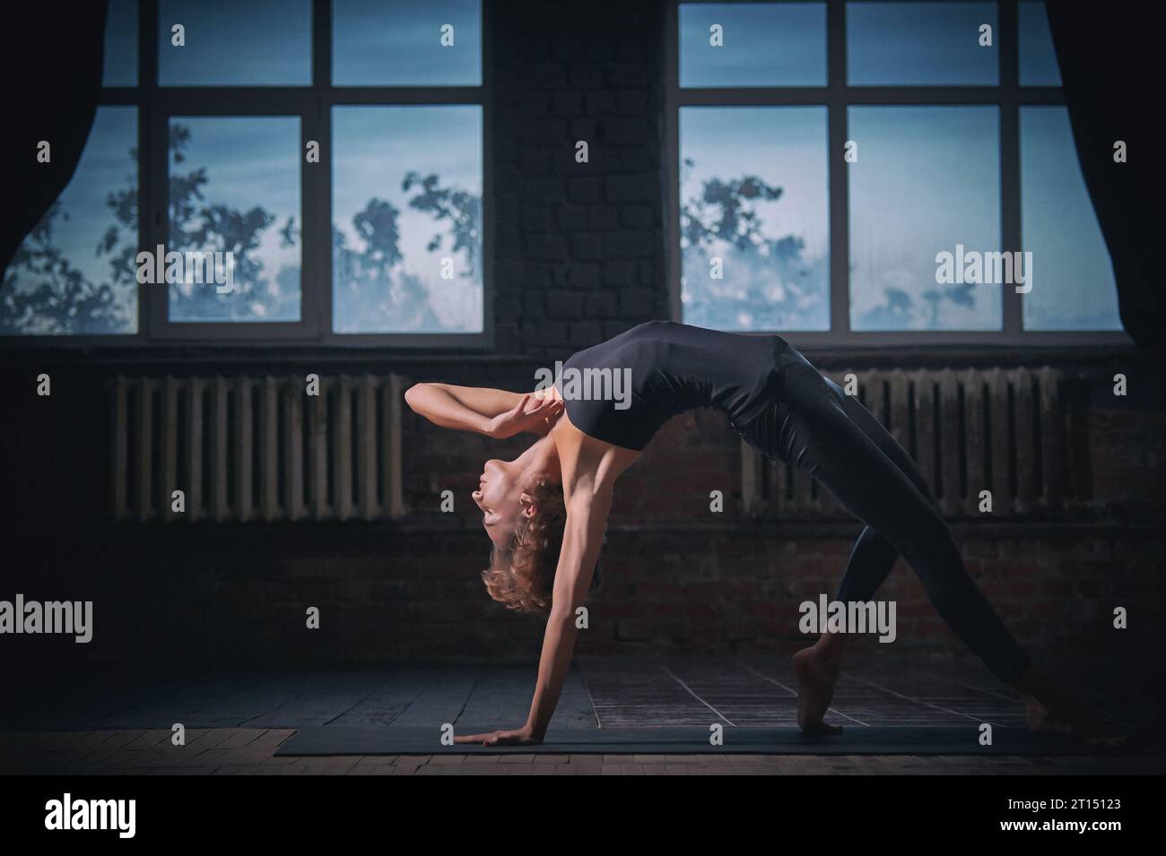 Beautiful sporty fit yogini woman practices yoga asana Wild Thing Pose ...