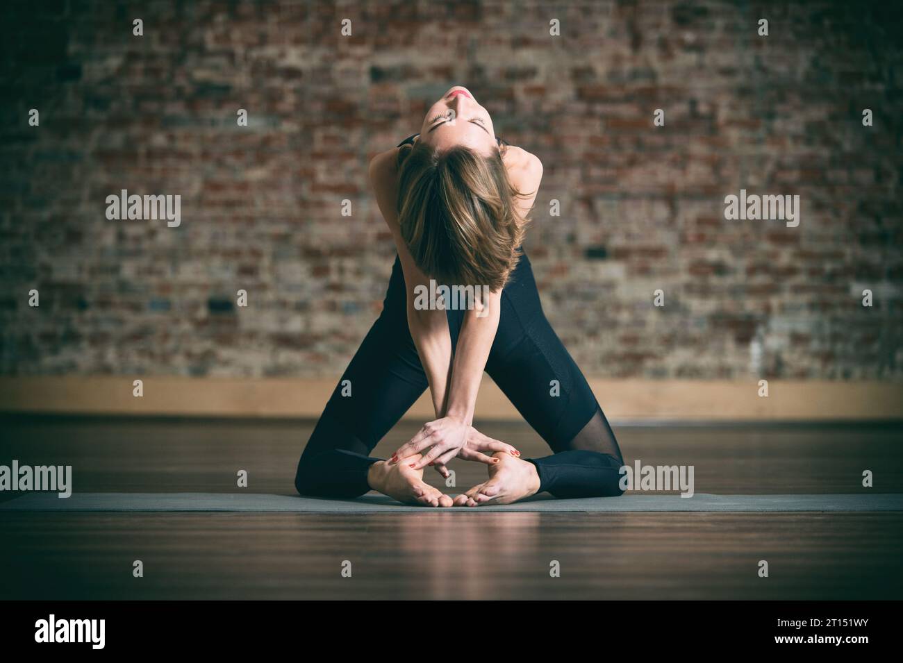 Beautiful young fit woman practices yoga asana Ushtrasana - Camel pose ...