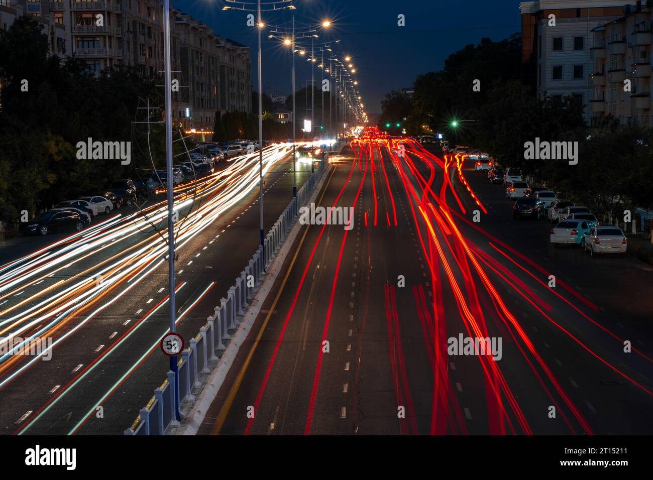 Traces of headlights of moving cars on the highway and street lights in ...