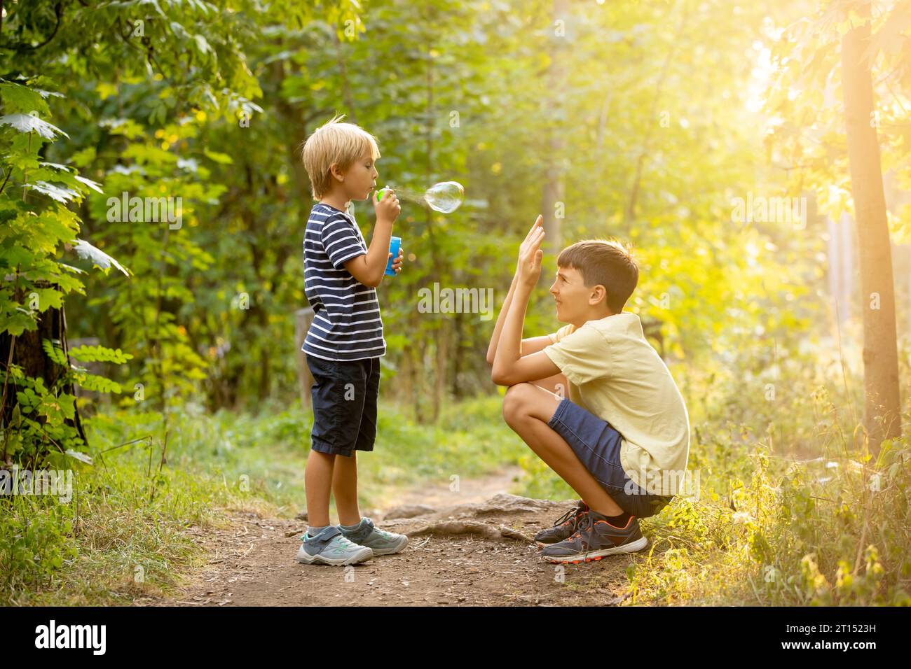 Sweet children, boys, playing in the park on sunset, autumntime ...