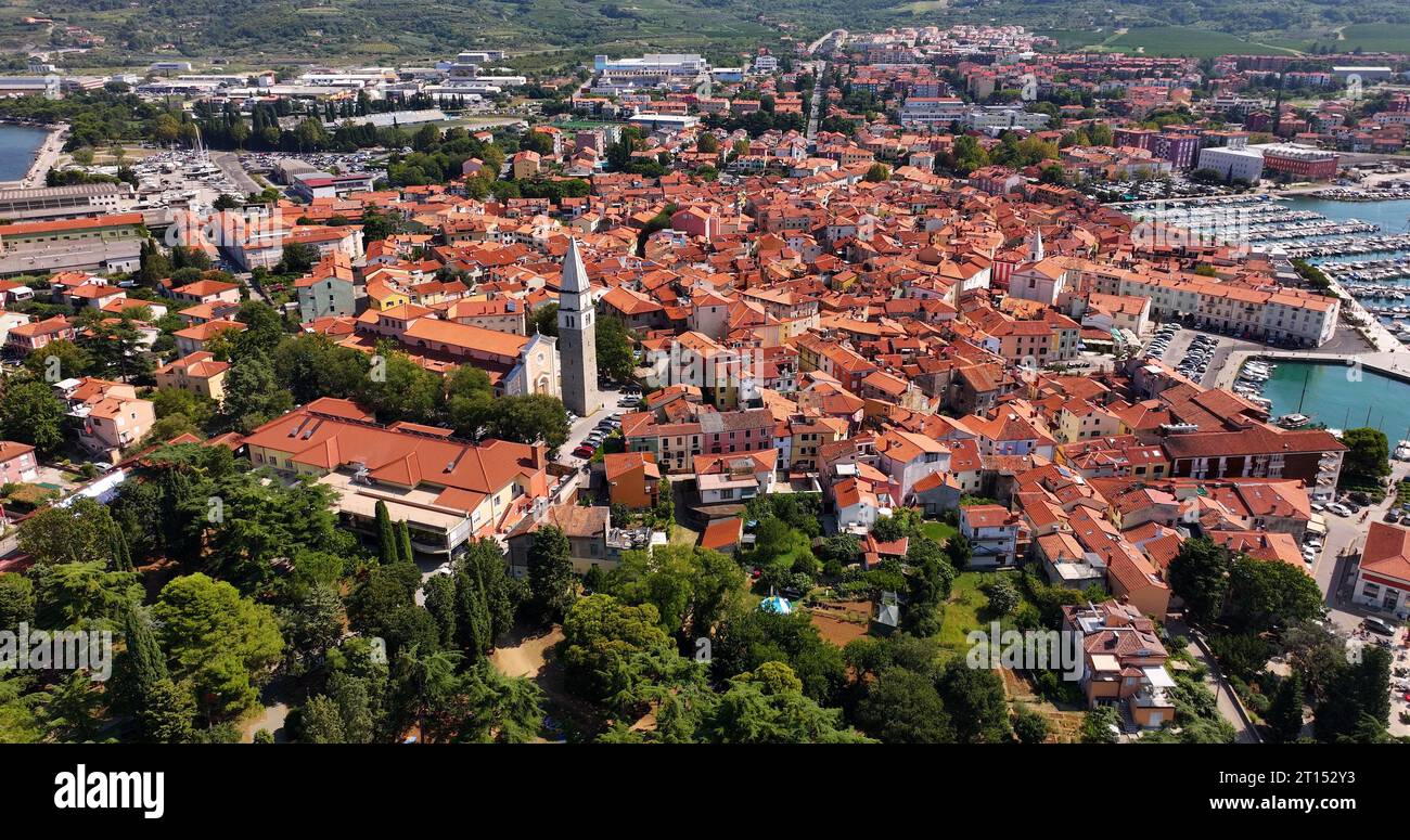 Aerial view of Izola, Church of St. Maurus, Gothic bell tower, a town ...
