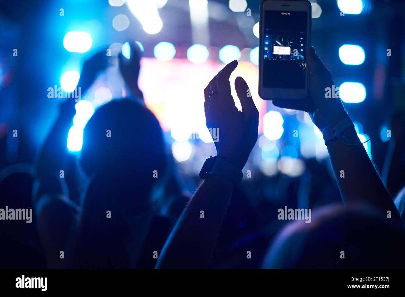 Crowd of audience with hands using camera phone to take pictures and ...