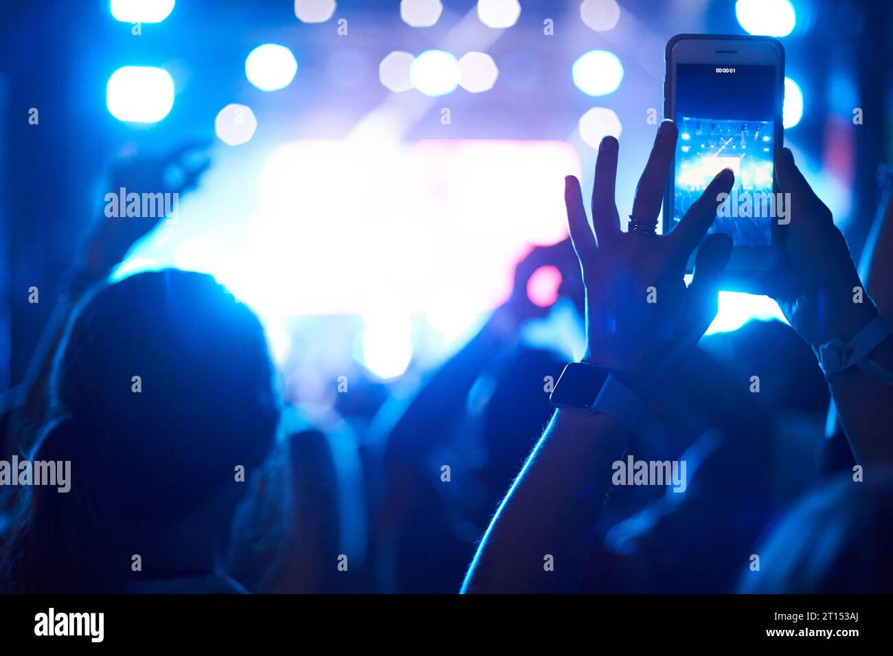 Crowd of audience with hands using camera phone to take pictures and ...