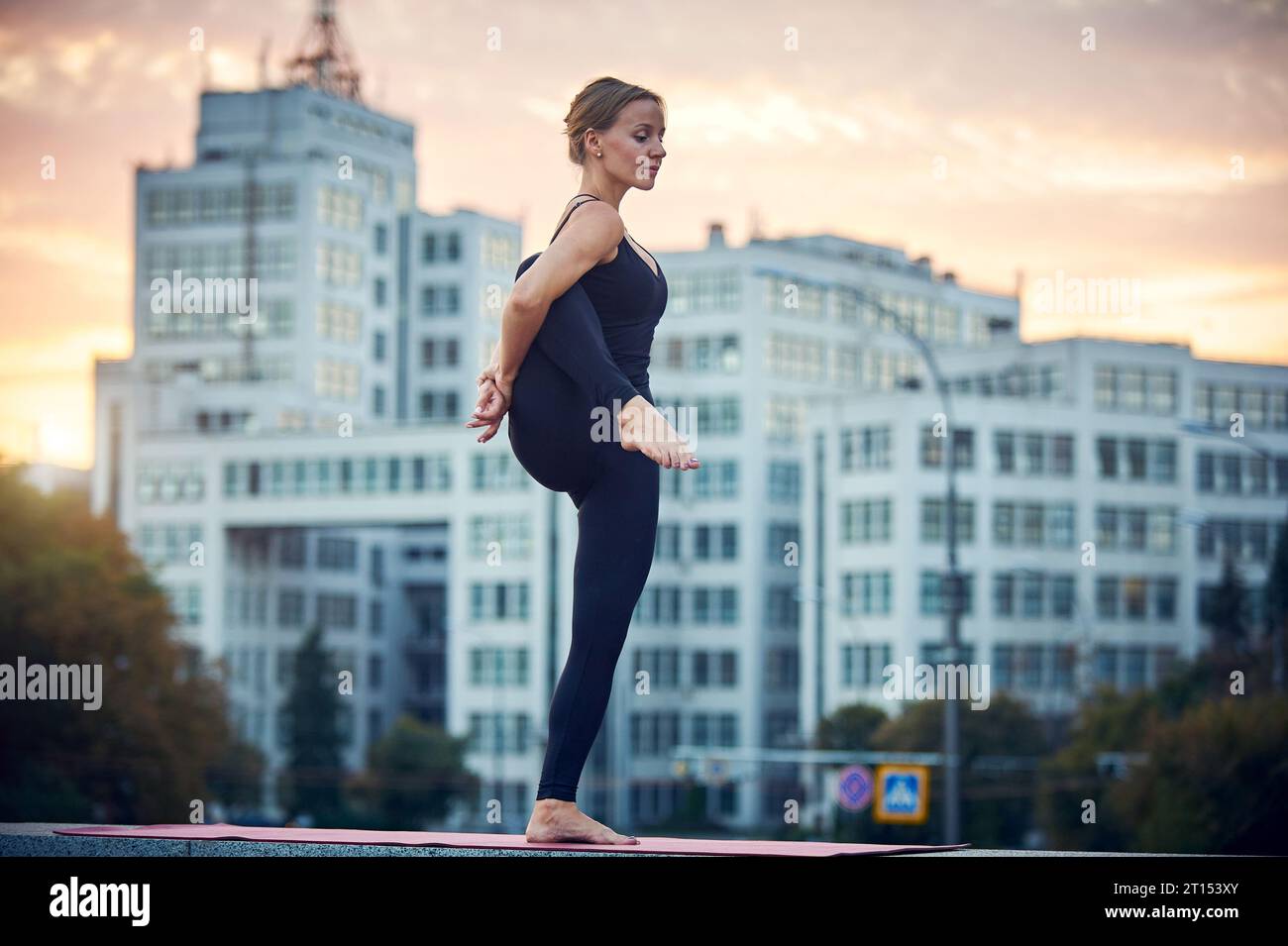 Beautiful young woman practices yoga asana Utthita Hasta ...