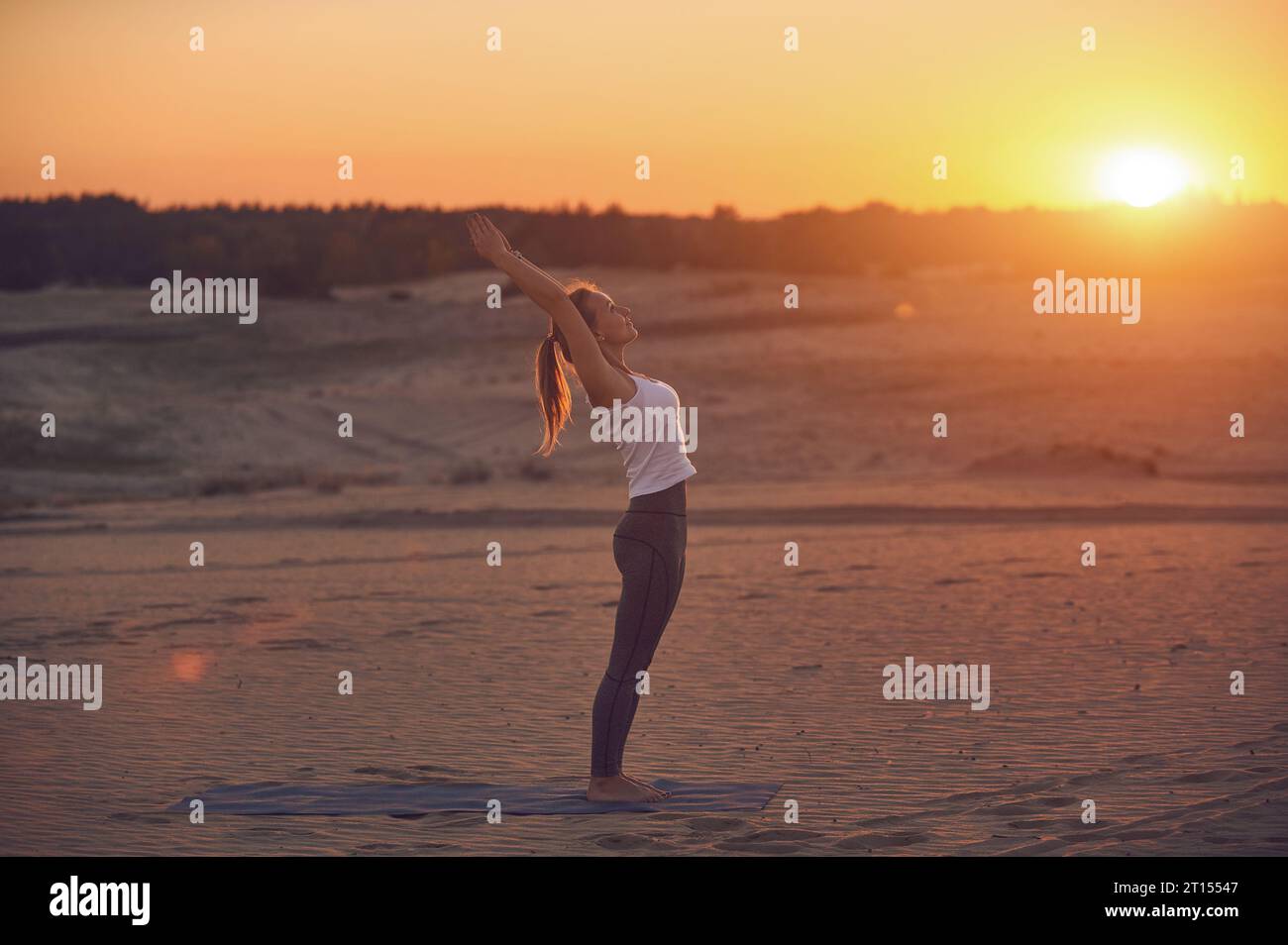 Beautiful young woman practices yoga asana Ardha Chakrasana - Half ...