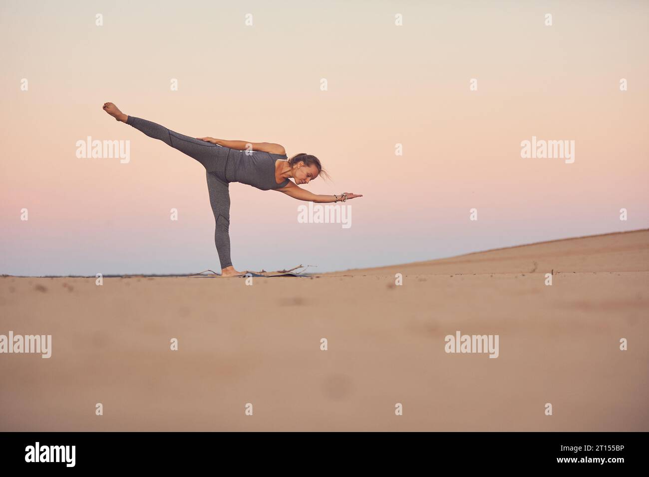 Beautiful young woman practices yoga asana Ardha Chandrasana - Half ...