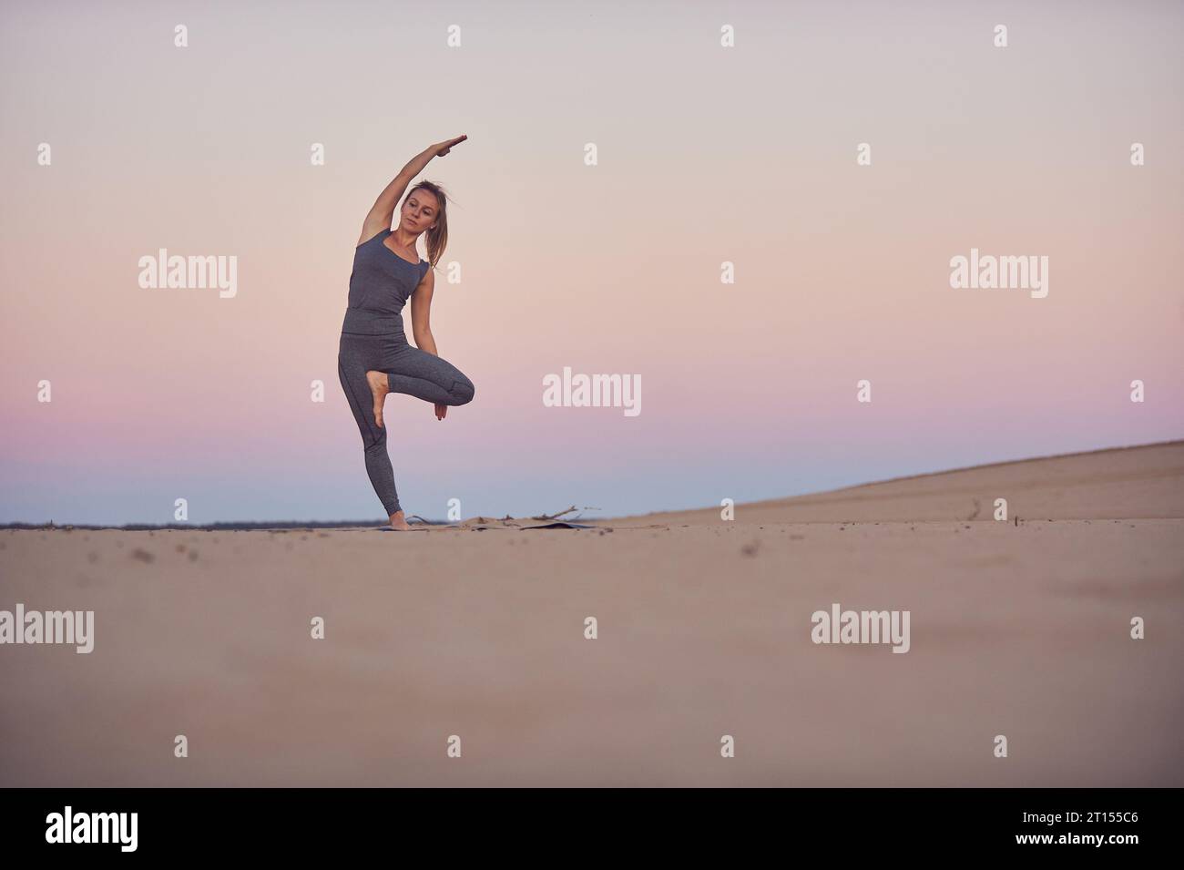 Beautiful young woman practices yoga asana Parshva Vrikshasana - Tree ...