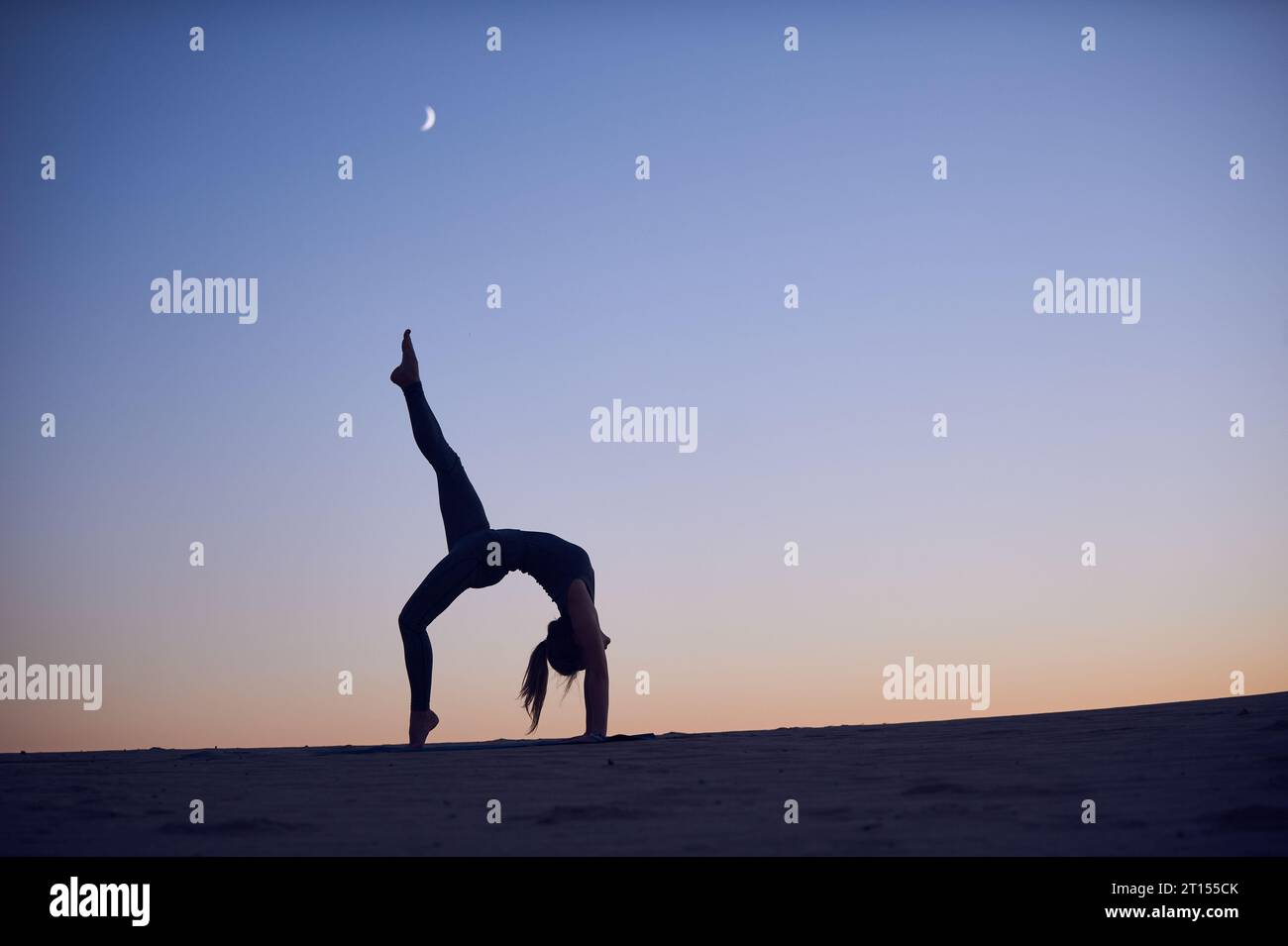 Beautiful young woman practices backbend yoga asana Eka Pada Urdhva ... Beautiful young woman practices backbend yoga asana Eka Pada Urdhva ...