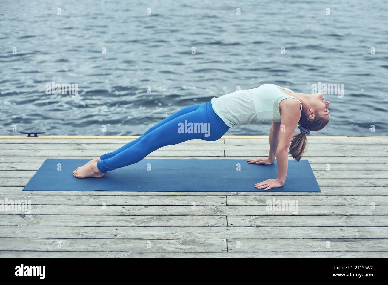 Beautiful young woman practices yoga asana Purvottanasana Upward Plank ...