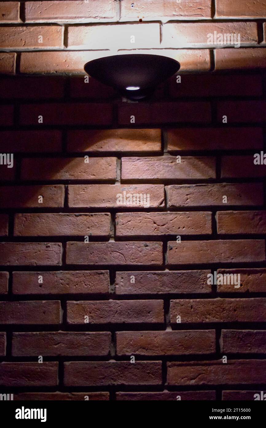 exposed brick wall illuminated by a two-way fixture Stock Photo - Alamy