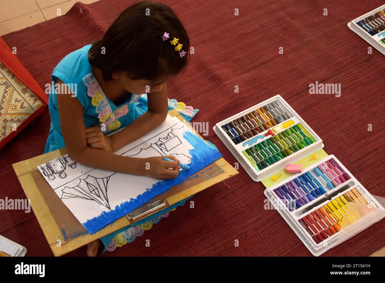 Dhaka. 11th Oct, 2023. A child draws during the 22nd Dreamland China ...