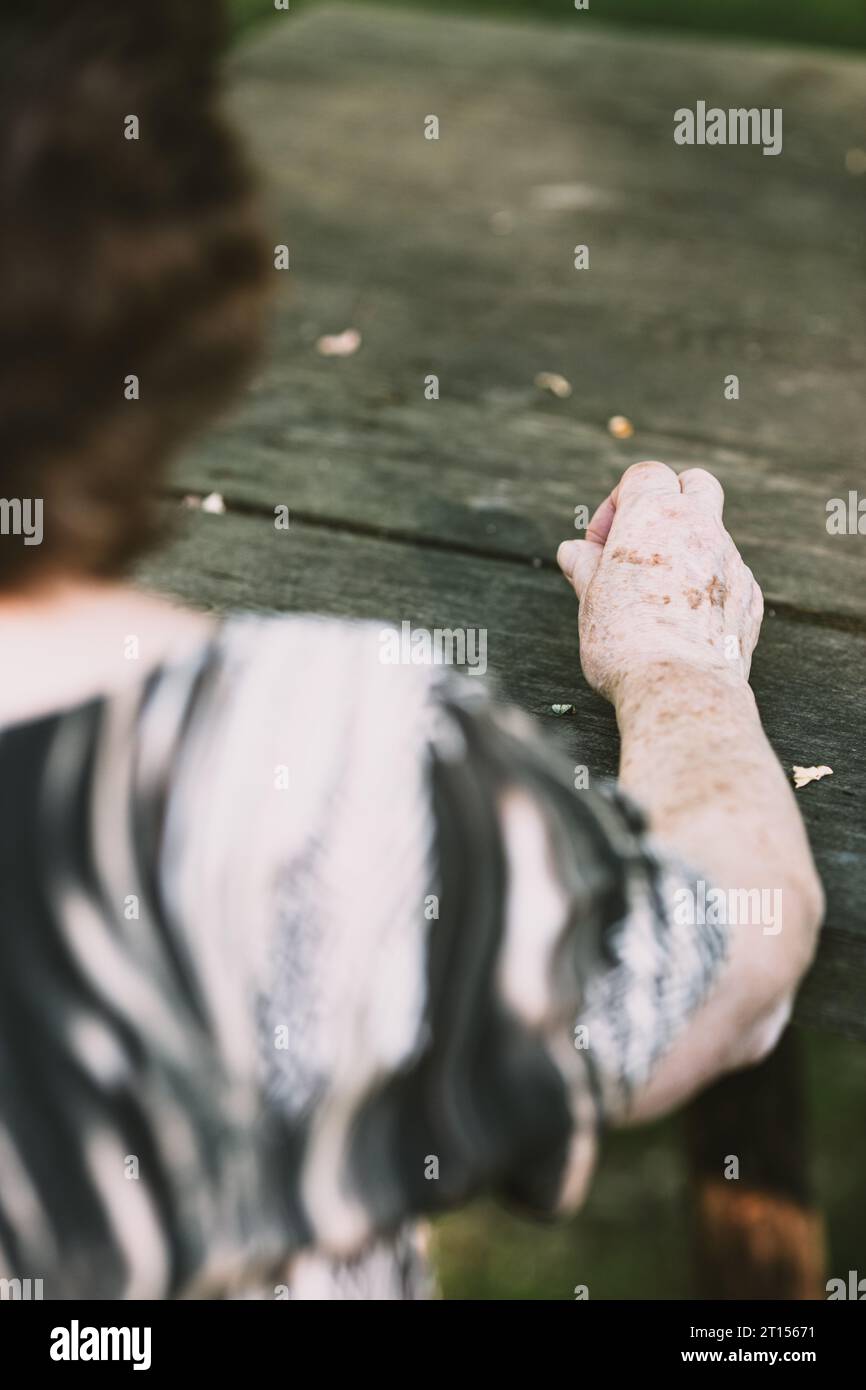 Elderly hands, wrinkled and veined, symbolize aging after enduring life ...