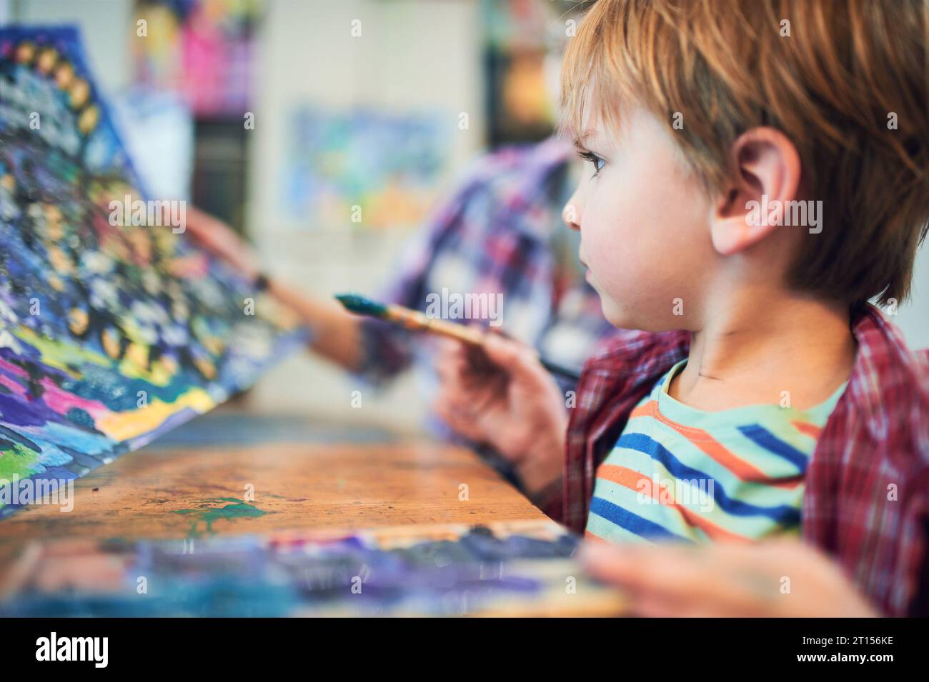 Cute happy little boy and teacher drawing in artist class. Education ...