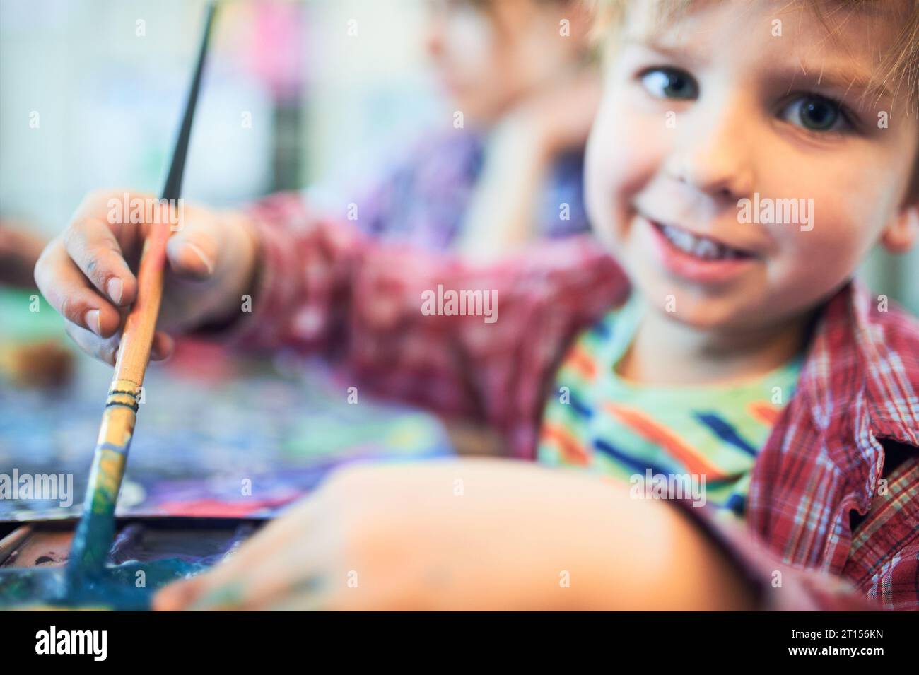 Cute happy little boy and teacher drawing in artist class. Education ...