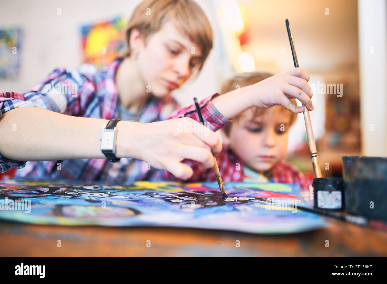 Cute happy little boy and teacher drawing in artist class. Education ...