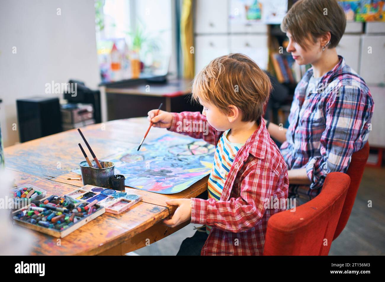Cute happy little boy and teacher drawing in artist class. Education ...