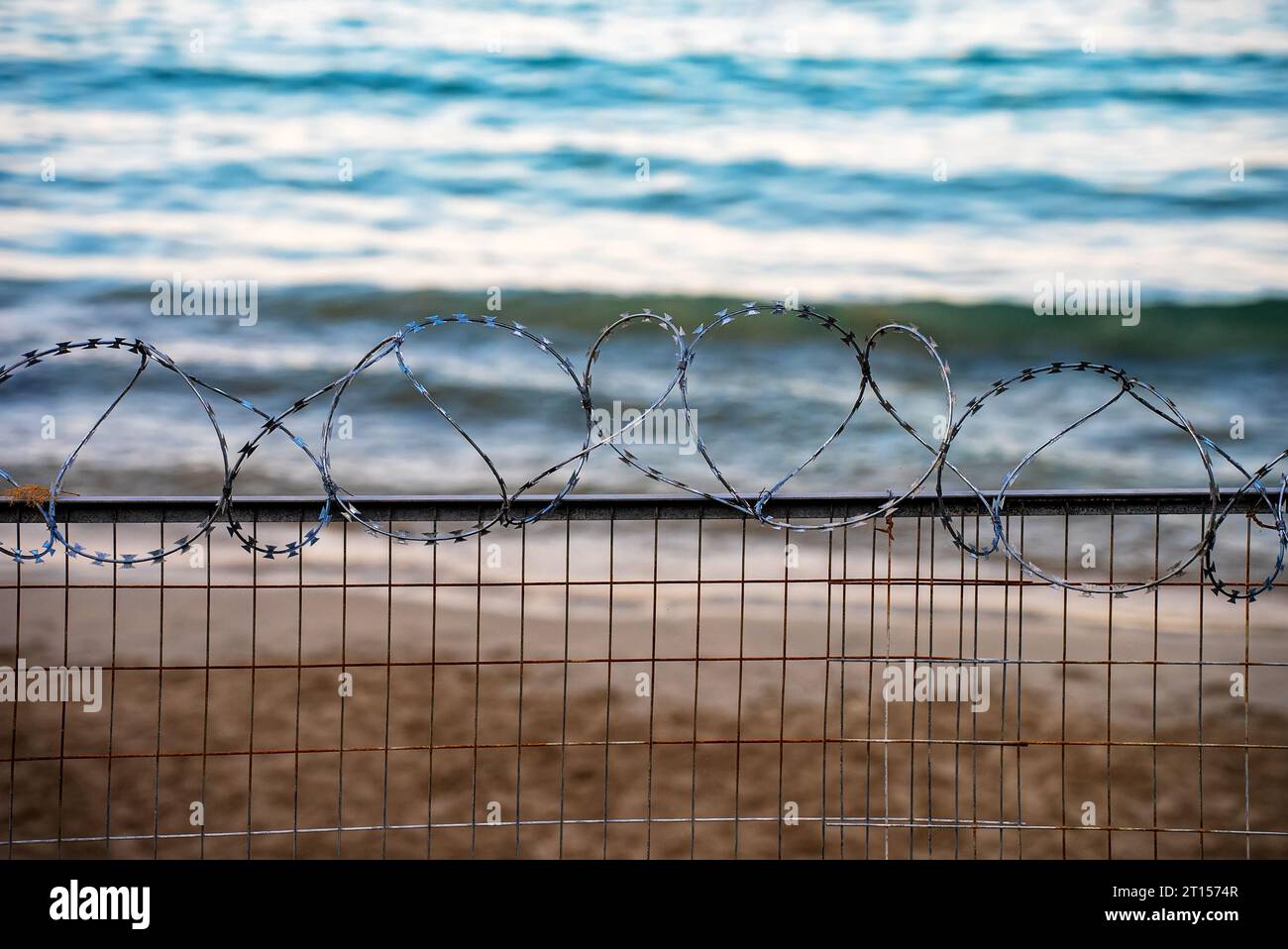 Sea and beach behind barbed wire Stock Photo - Alamy