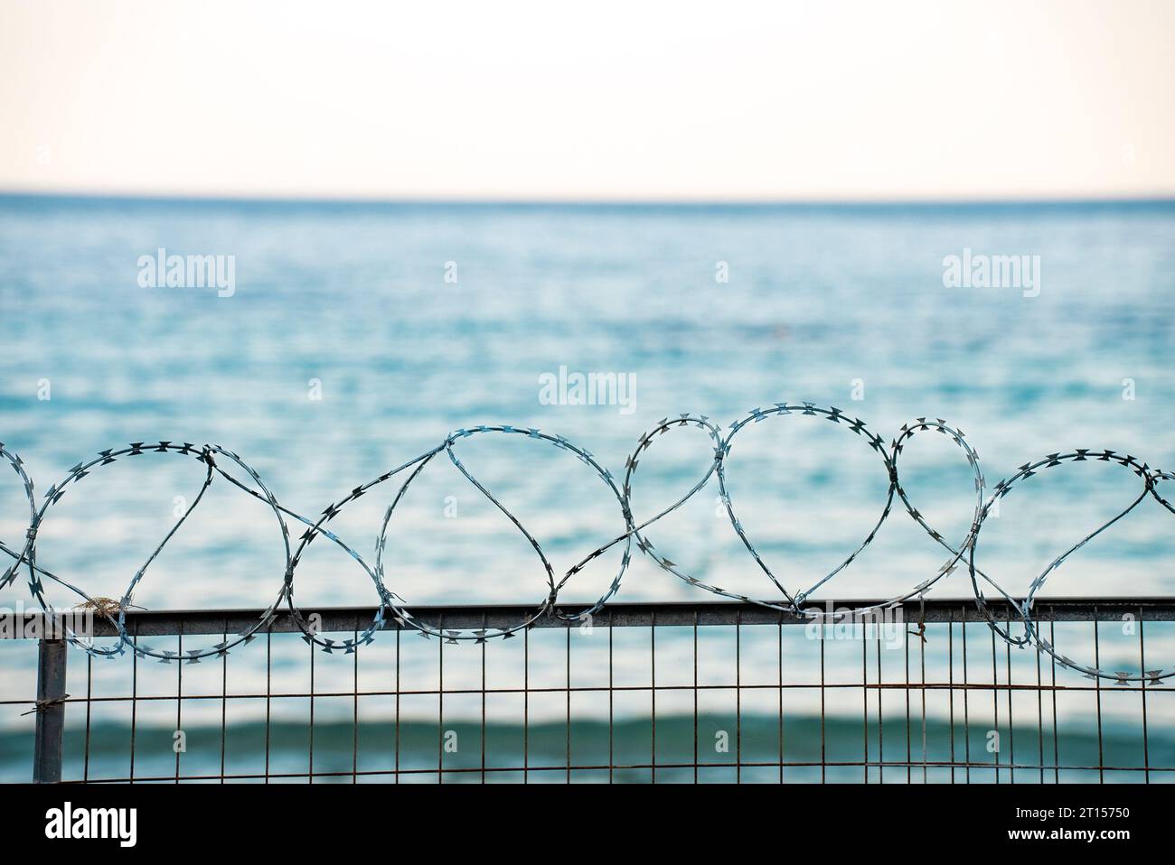 Sea and beach behind barbed wire Stock Photo - Alamy