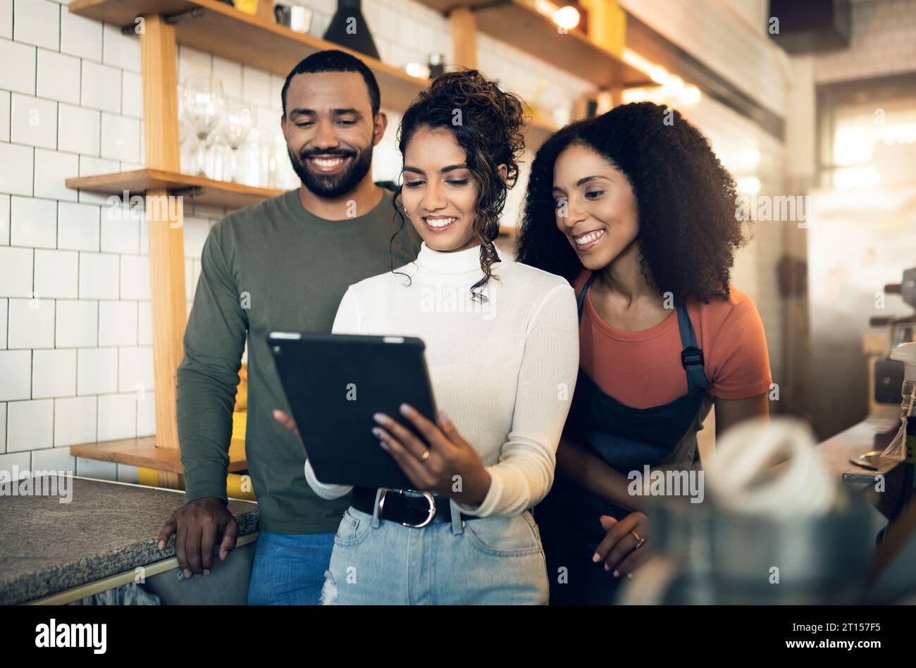 Barista group, coffee shop and together with smile, tablet and planning ...