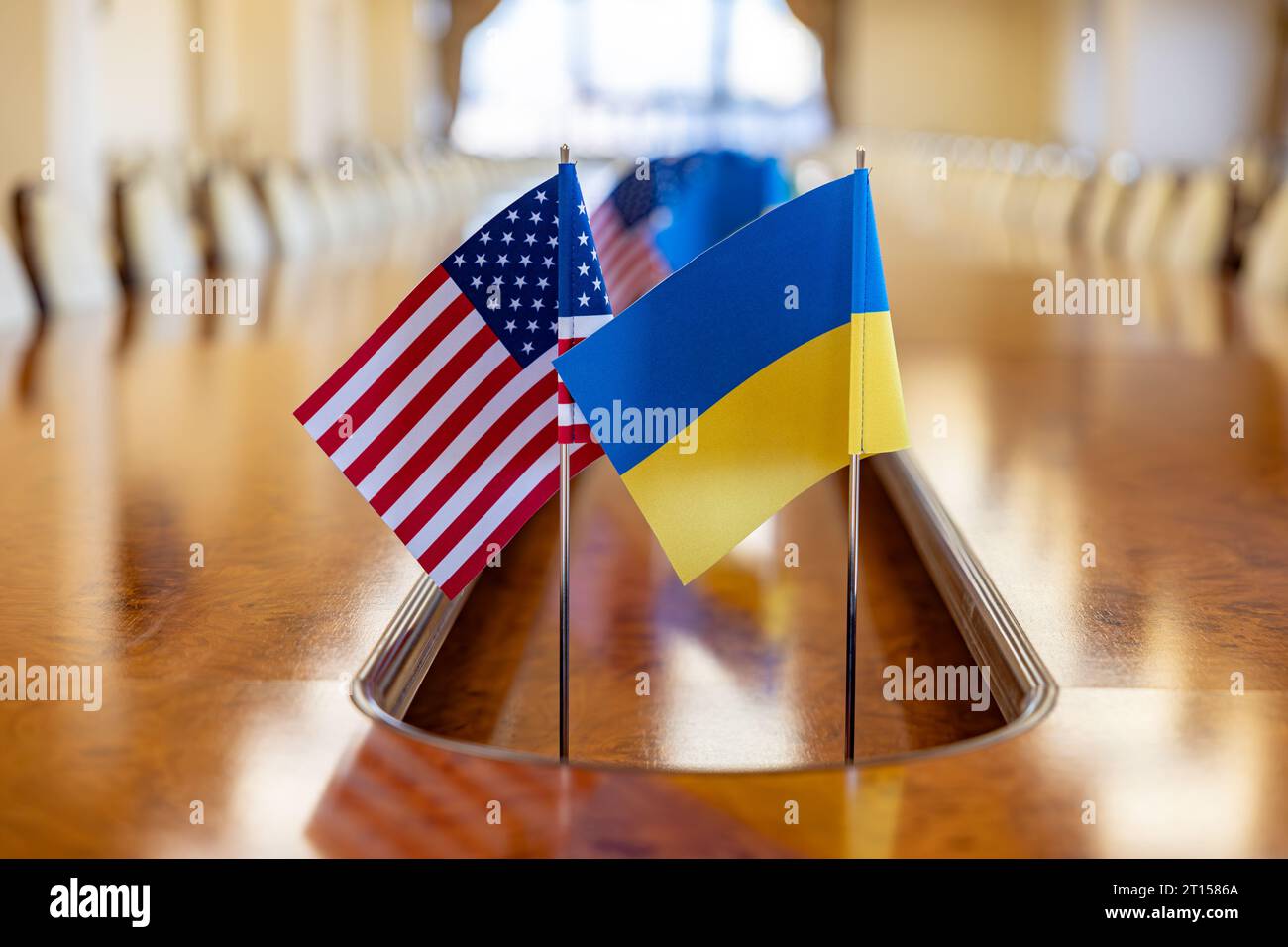 National flags of USA and Ukraine on table and hands of heads of ...