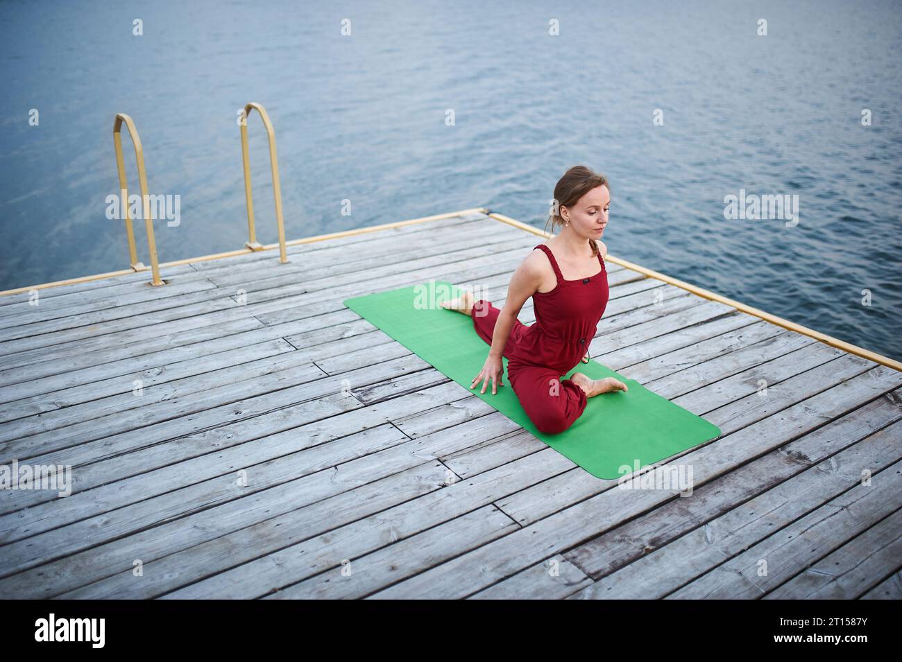 Beautiful young woman practices yoga asana One Legged King Pigeon Pose ...