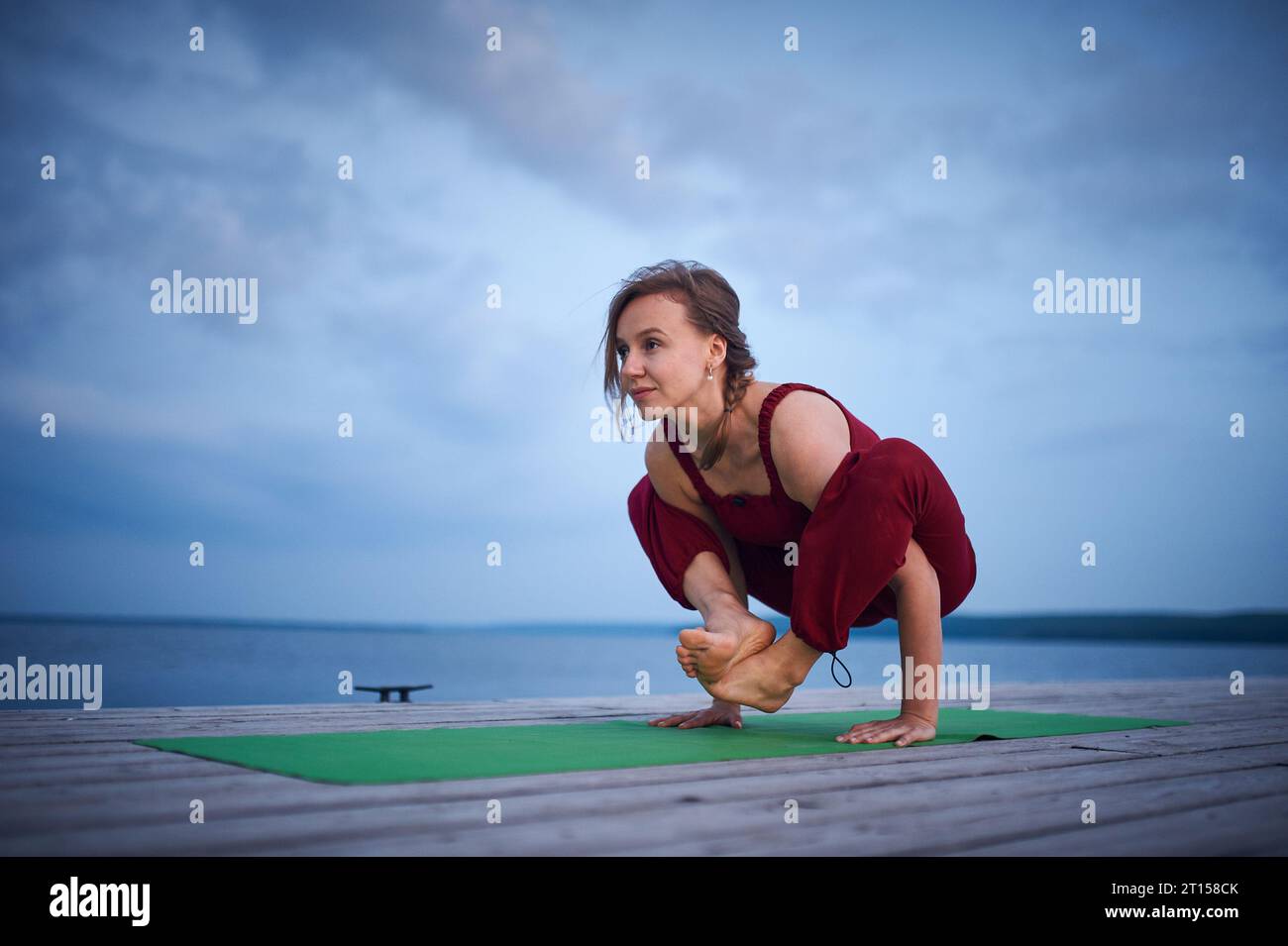 Beautiful young woman practices yoga asana Malasana - Garland pose on ...