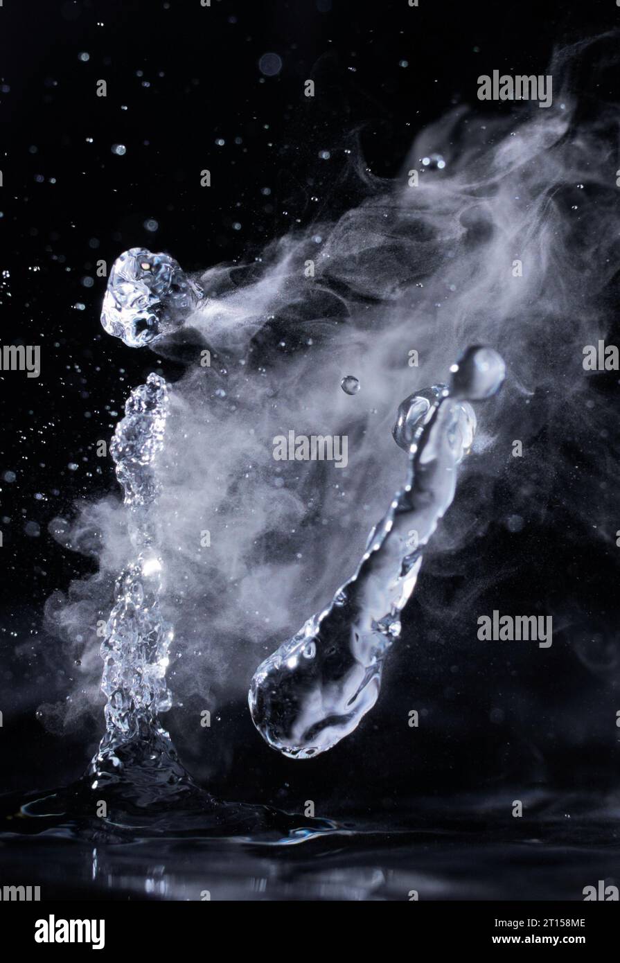 Boiling water splash with steam on black background closeup Stock Photo ...