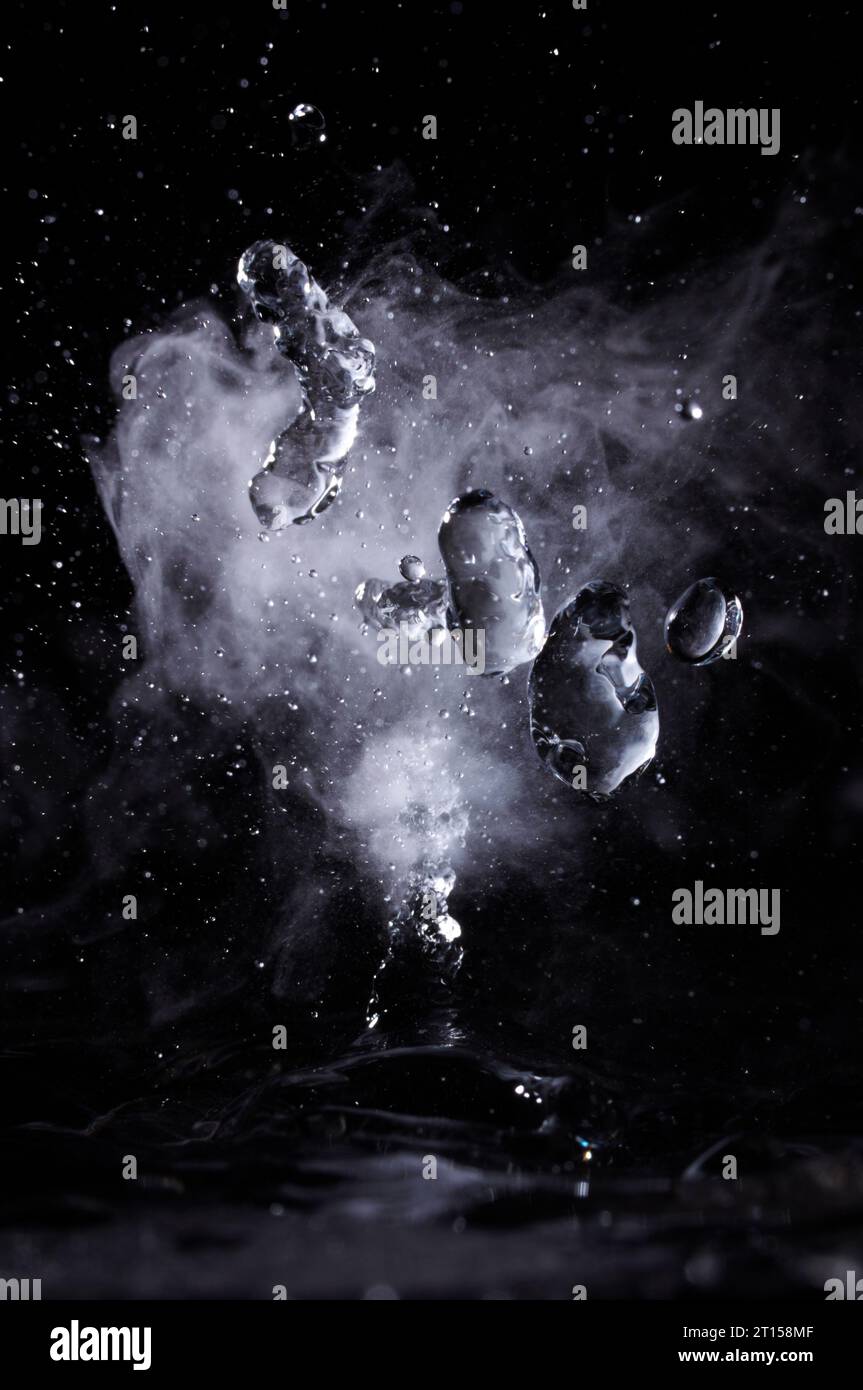 Boiling water splash with steam on black background closeup Stock Photo ...