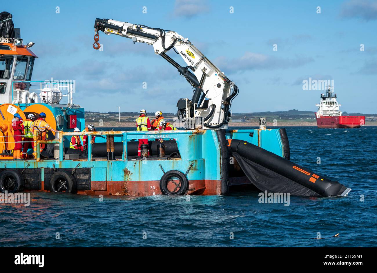 Crew onboard the Jif Worker, a multi-cat vessel, deploy a heavy duty ...