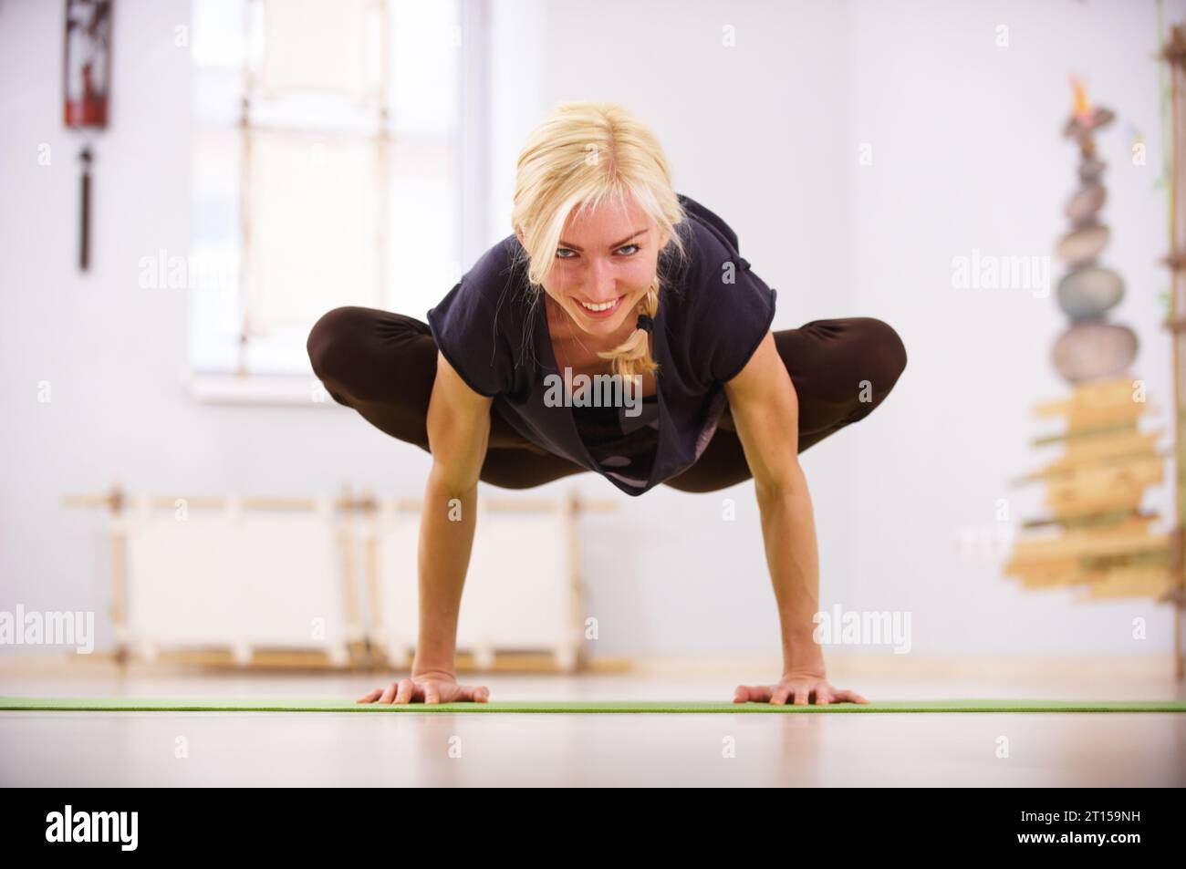Beautiful sporty fit yogi woman practices yoga asana Padma Bakasana ...