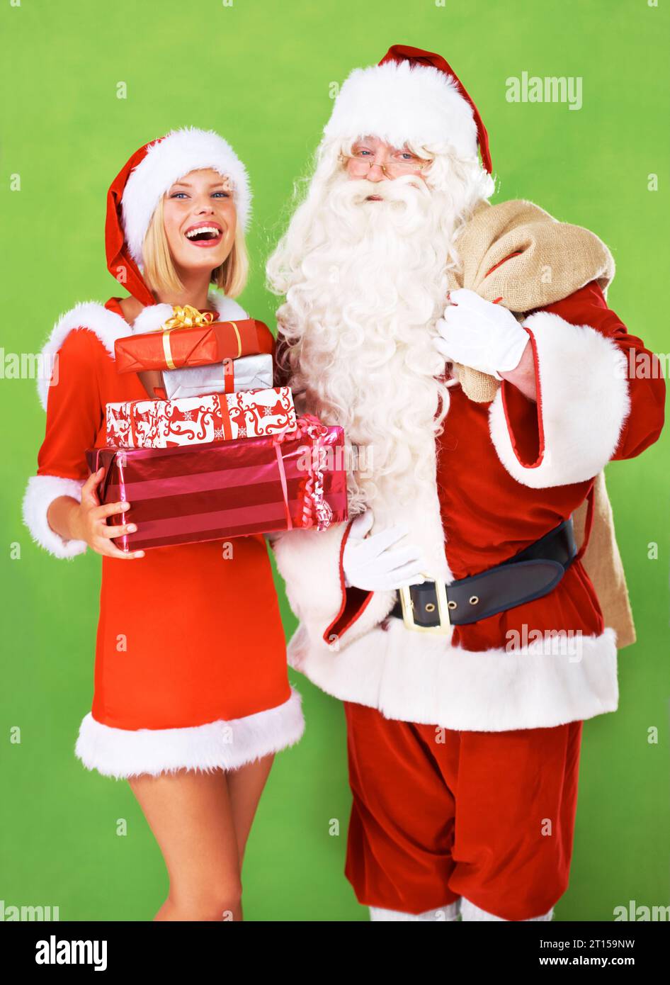 Santa claus, helper or Christmas gift box on studio green background ...
