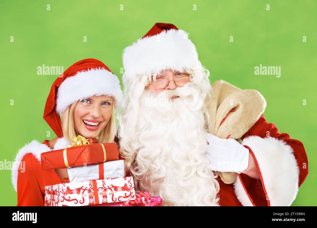 Santa claus, woman and hug for Christmas gift in studio holiday ...