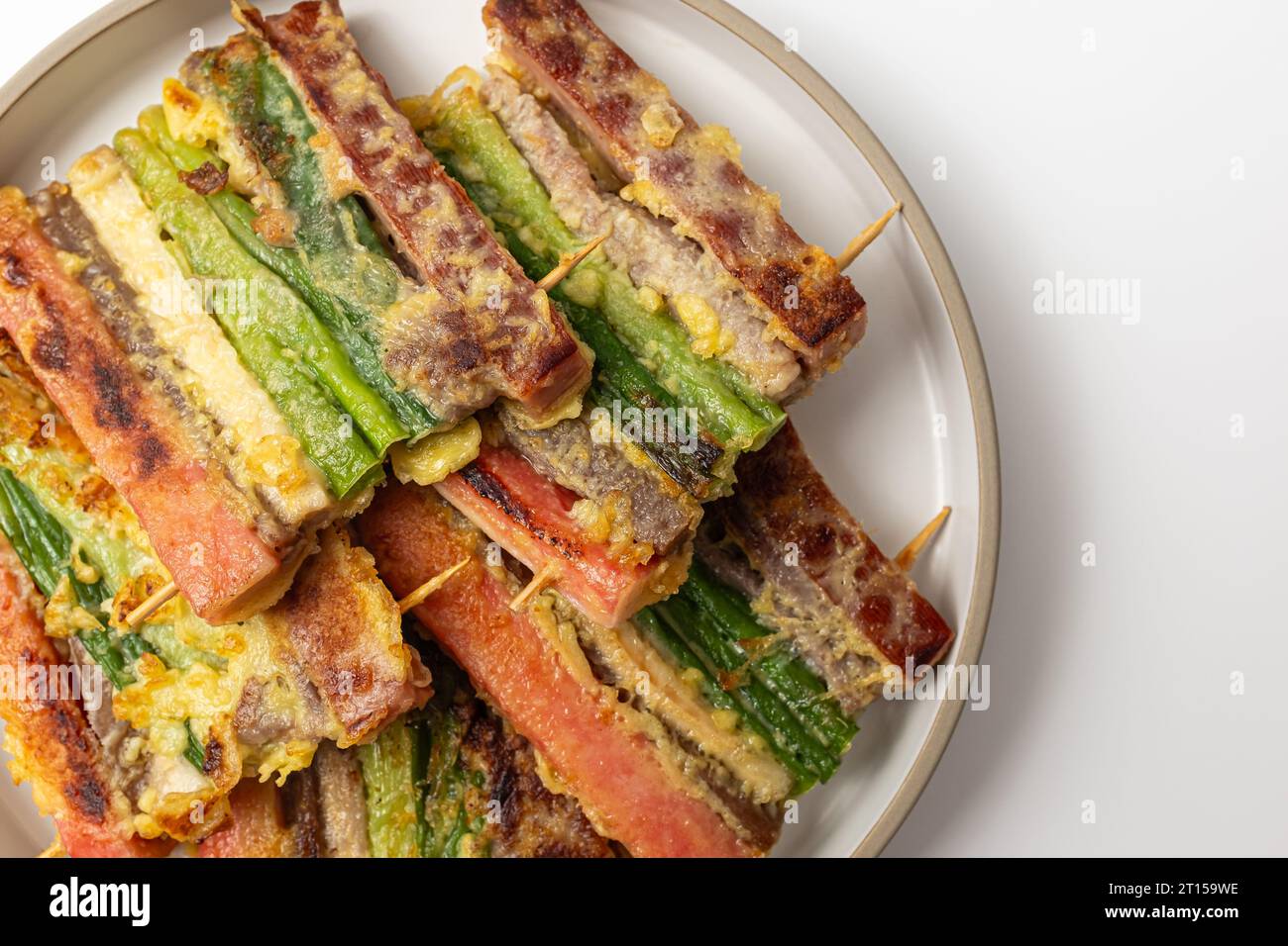 Korean holiday food skewers Jeon on white background Stock Photo - Alamy