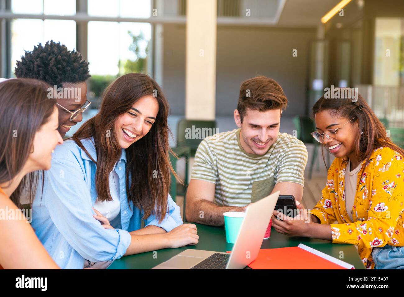 Multiracial group of happy friends studying in university - Young ...