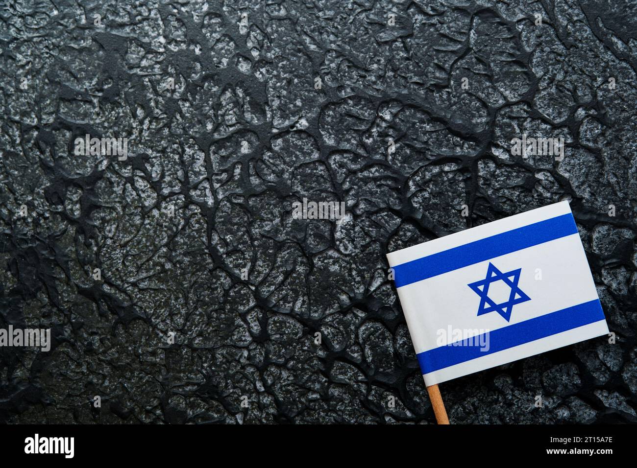 USA Israel flags. Two small American and Israeli flags lie on black old ...